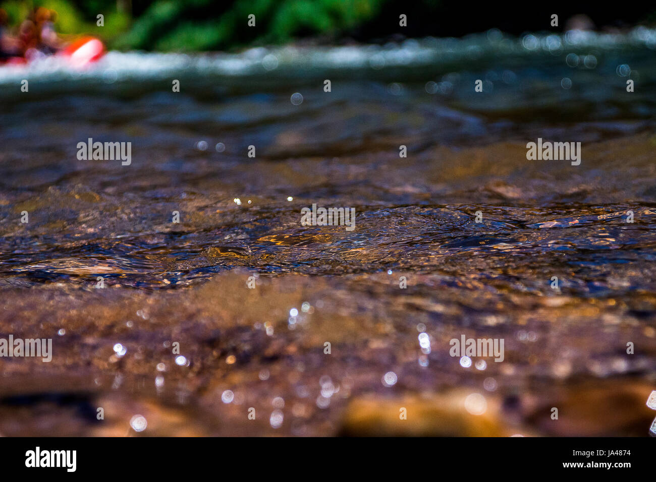 Roaring river surface with kayak in the background Stock Photo - Alamy