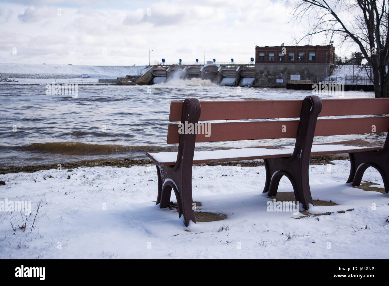 bench overlooking dam with spillway open Stock Photo - Alamy