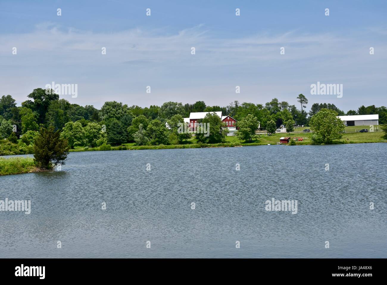 Red farm house on lake Stock Photo - Alamy