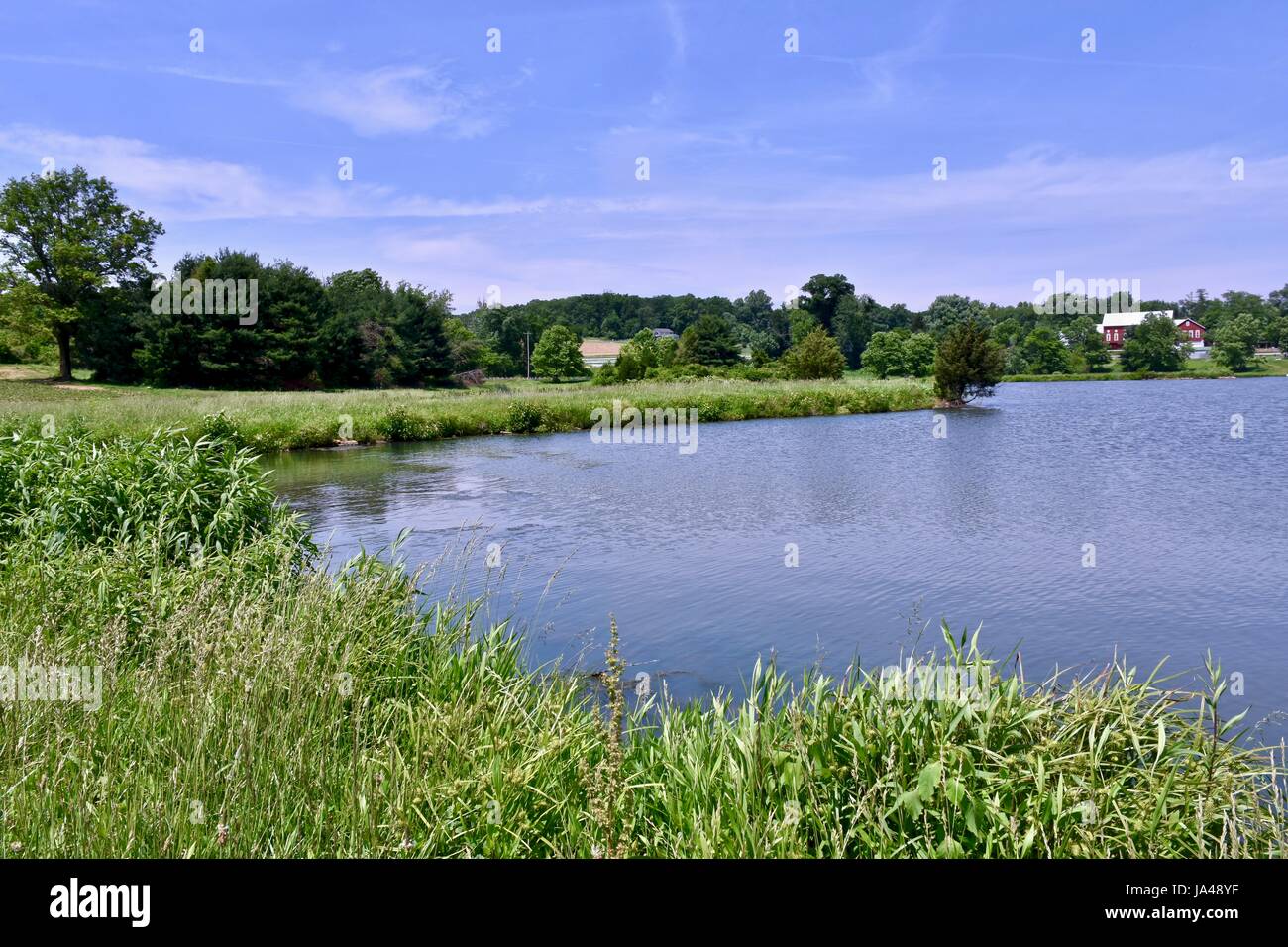Red farm house on lake Stock Photo - Alamy