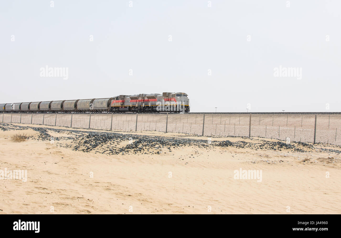 Cargo train passing a railway in the desert. Liwa desert, UAE Stock ...