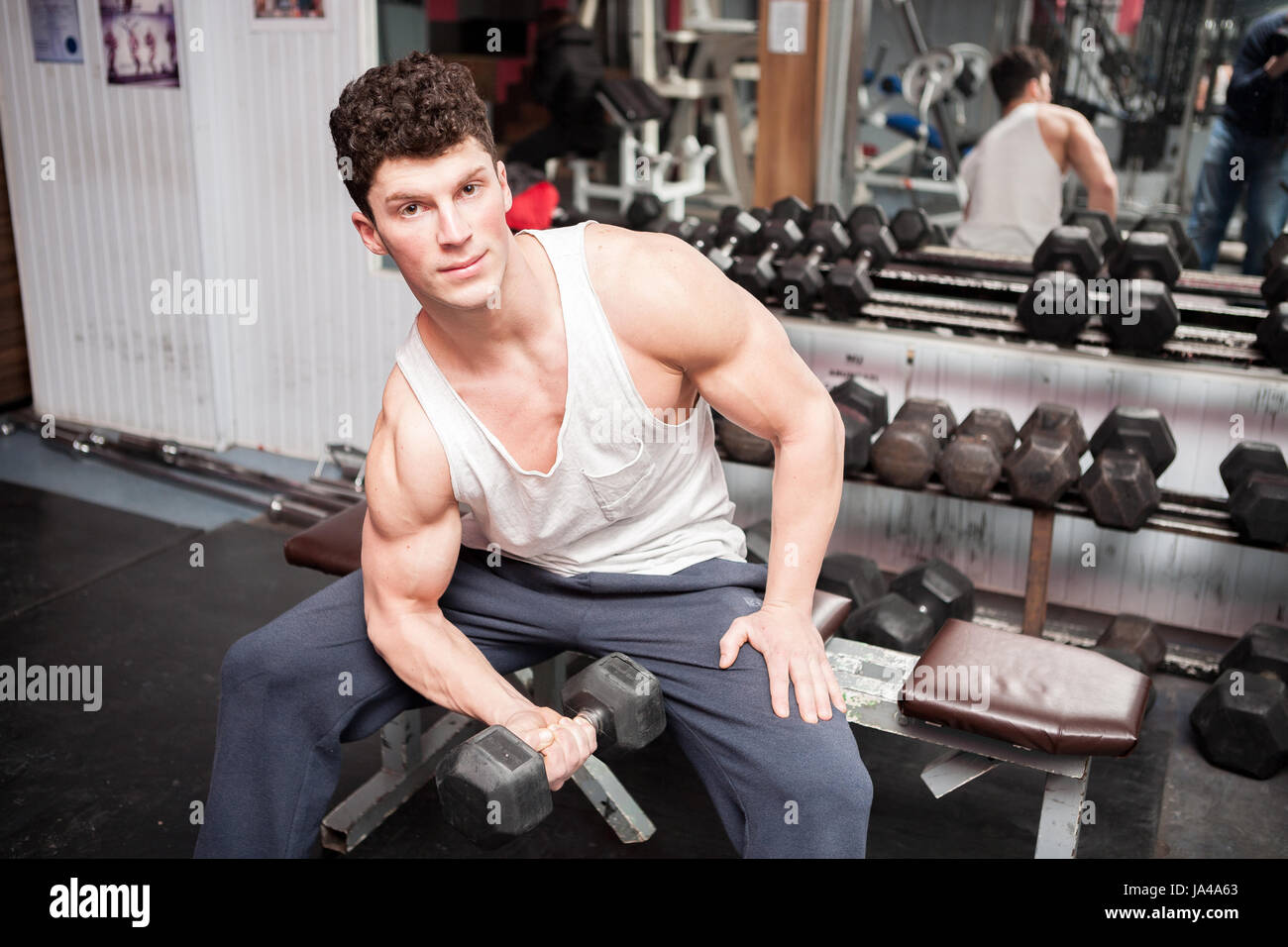 Muscular guy lifting heavy weights in the gym. Bodybuilder workout ...