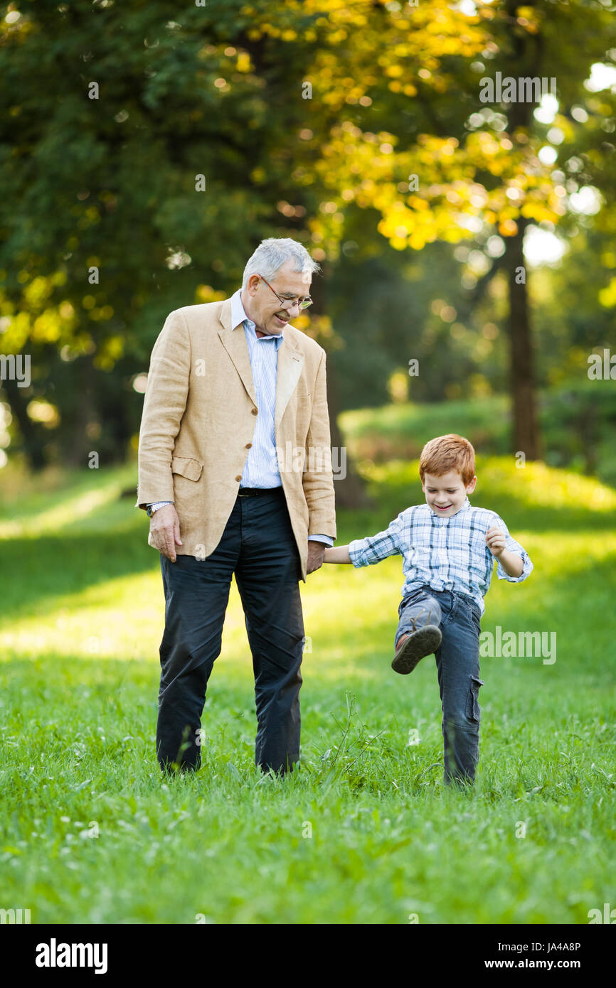 Grandfather and grandson in park Stock Photo - Alamy
