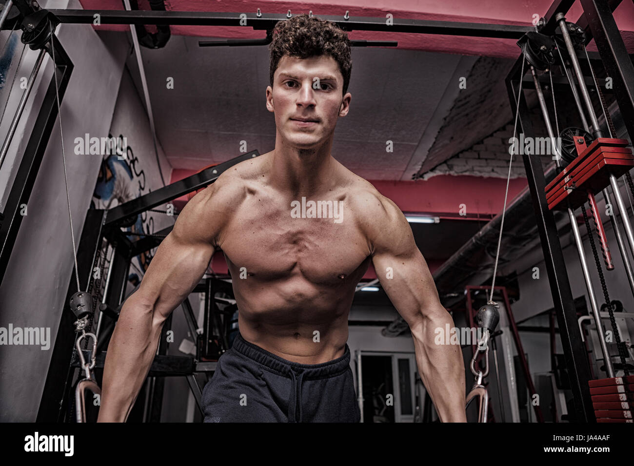Man in the gym exercising. Lifting heavy weights. Bodybuilder workout ...