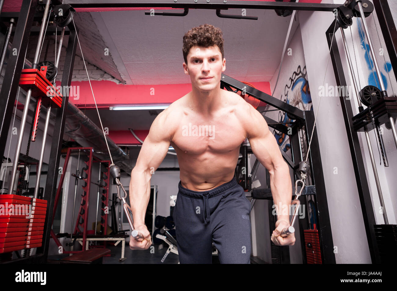 Man in the gym exercising. Lifting heavy weights. Bodybuilder workout ...