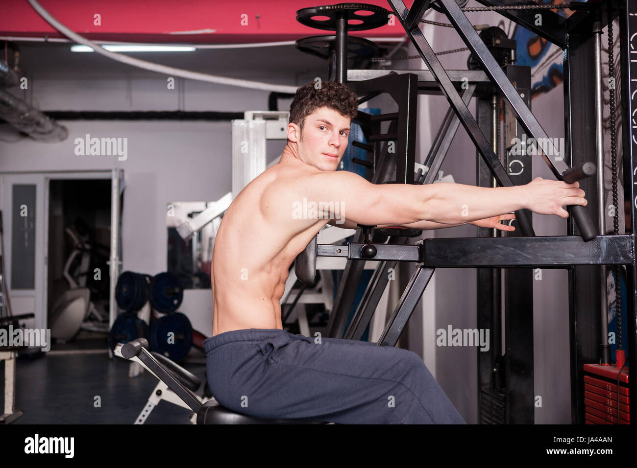 Man in the gym exercising. Lifting heavy weights. Bodybuilder workout ...
