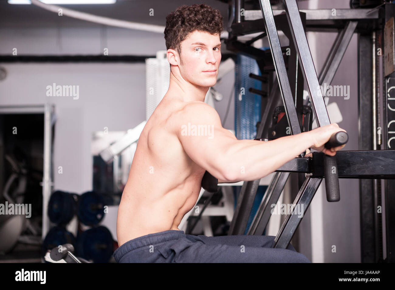Man in the gym exercising with heavy weights. Lifting heavy weights ...
