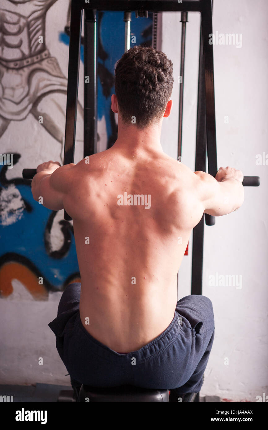 Man in the gym exercising with heavy weights. Lifting heavy weights ...