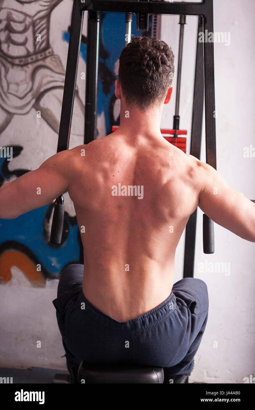 Man in the gym exercising with heavy weights. Lifting heavy weights ...