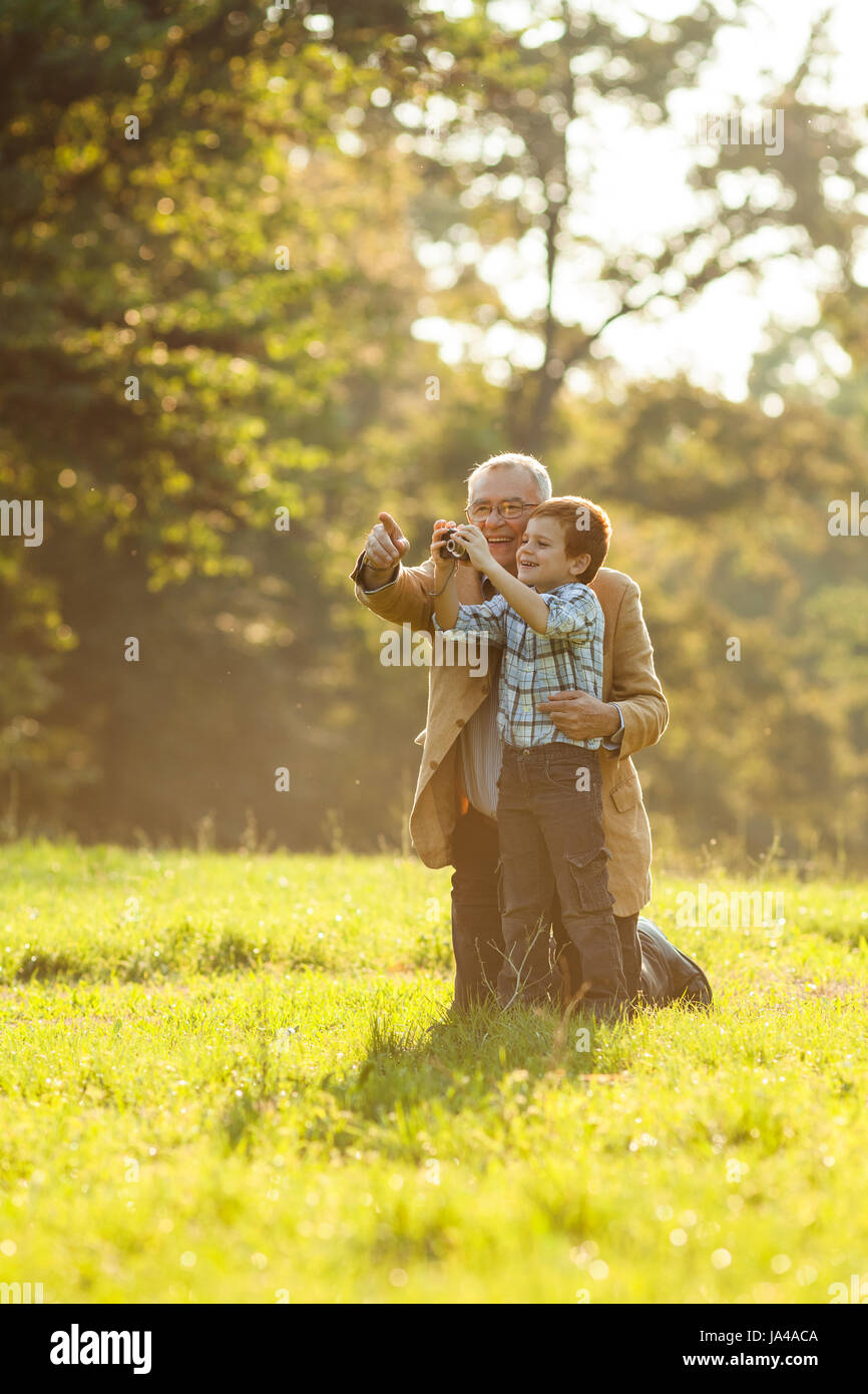 Grandfather and grandson in park Stock Photo - Alamy