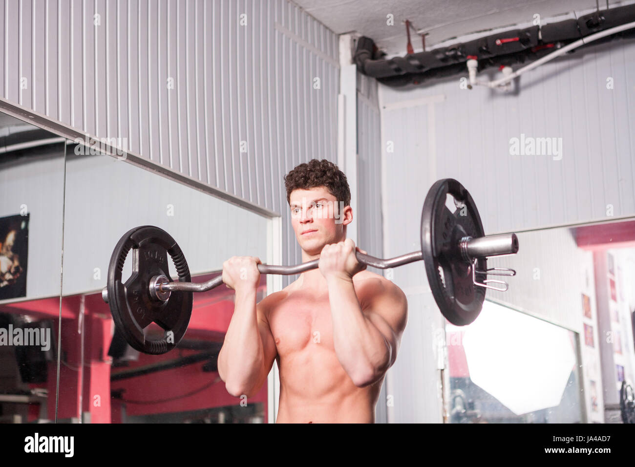 Exercising in the gym with heavy weights. Lifting heavy weights ...