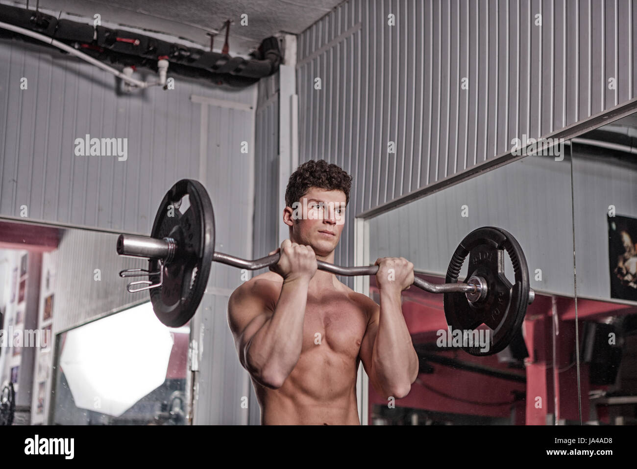 Exercising in the gym with heavy weights. Lifting heavy weights ...