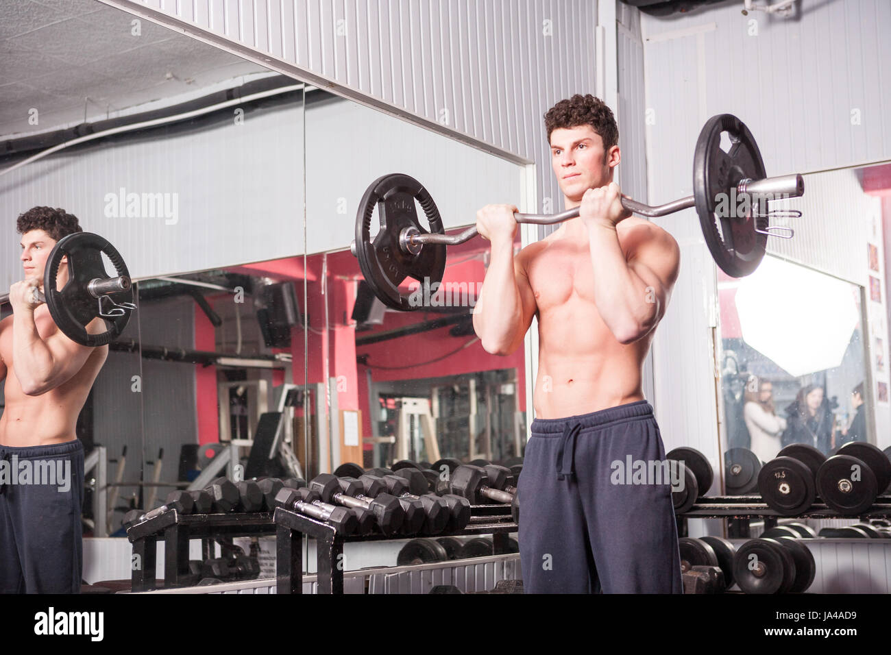 Exercising in the gym with heavy weights. Lifting heavy weights ...