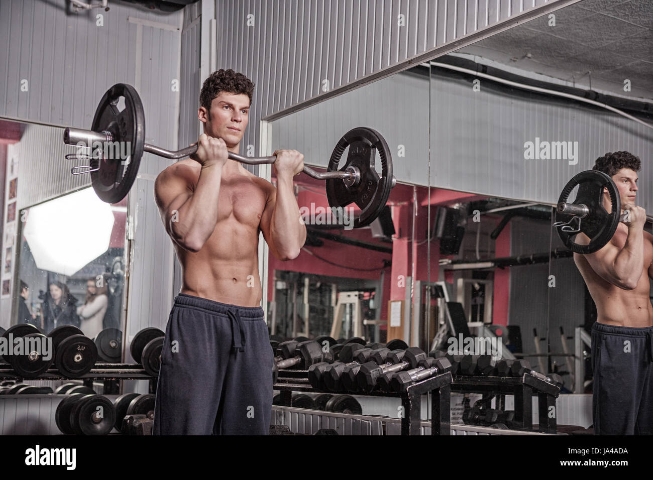 Exercising in the gym with heavy weights. Lifting heavy weights ...