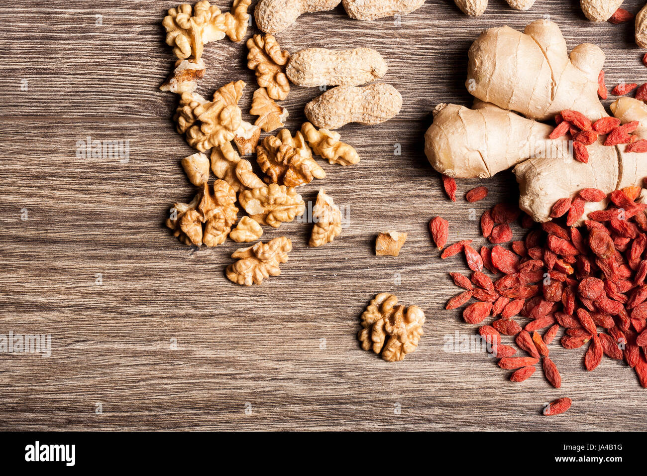 Mix of different type of nuts on wooden background in studio photo ...