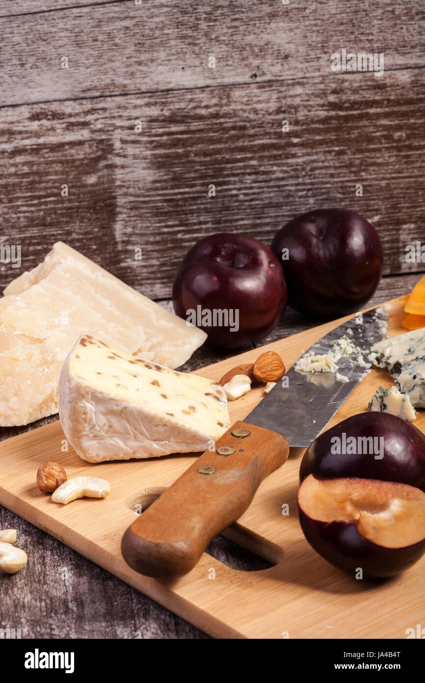 Healthy snaks from different type of cheese, nuts and plums. Healthy ...