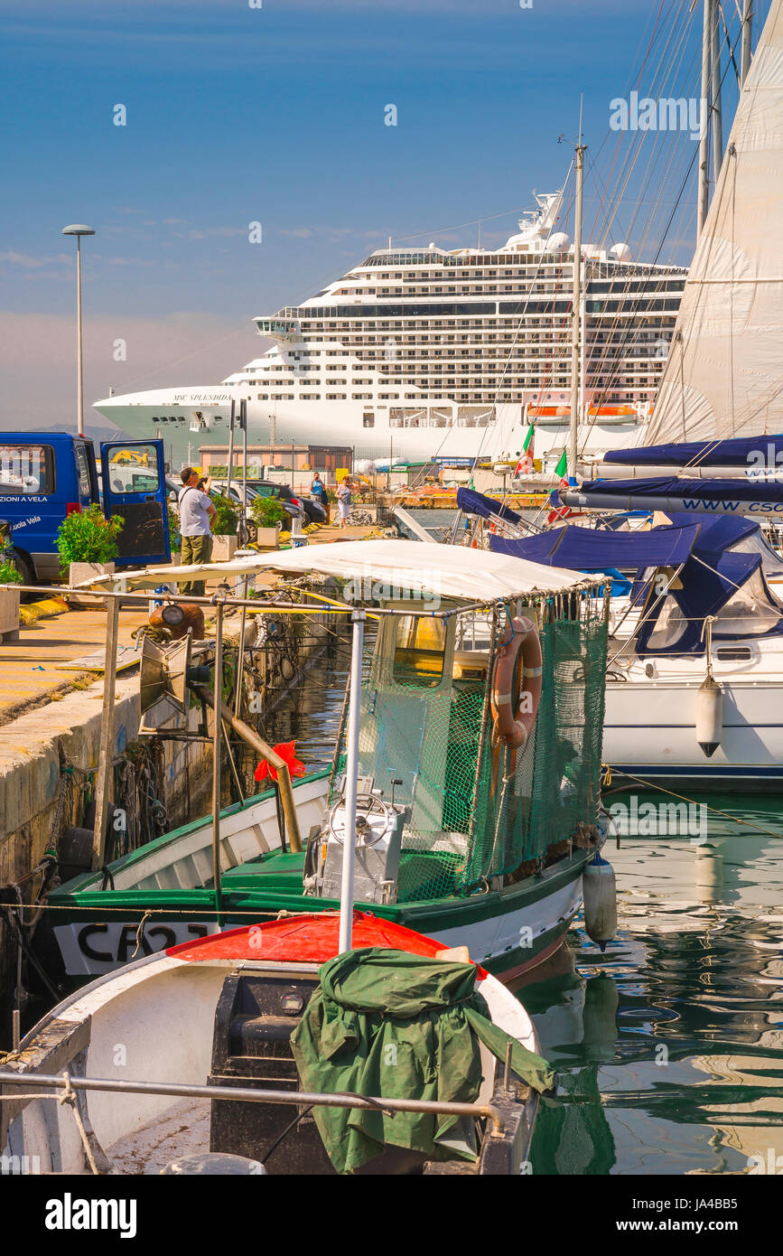 Cagliari port, fishing boats and a luxury cruise ship moored along the ...