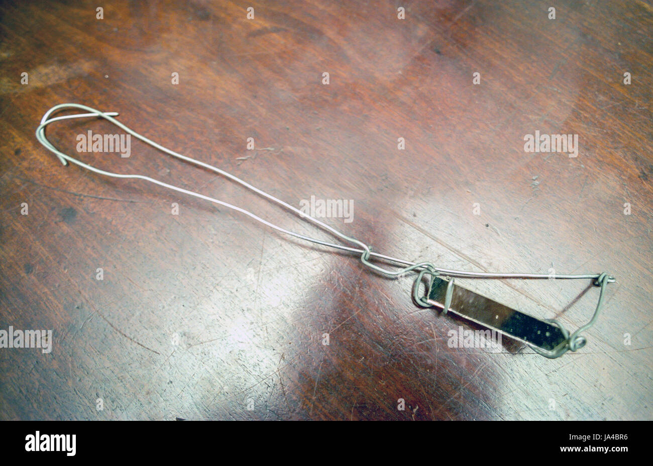 A hand-fashioned mirror device, used to see around corners, brought ...