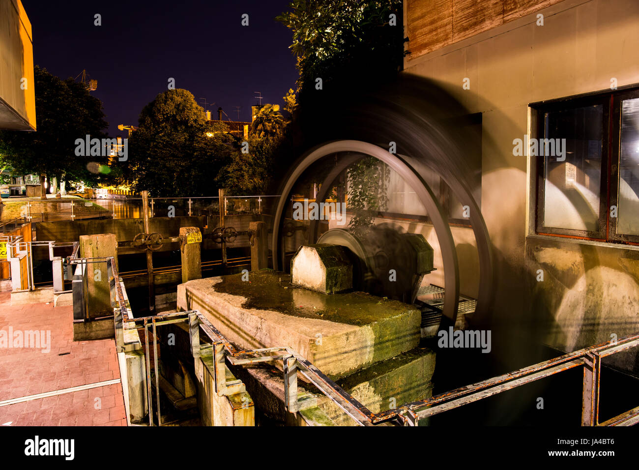 Fabulous water mill in the center of the city at night. Old ...