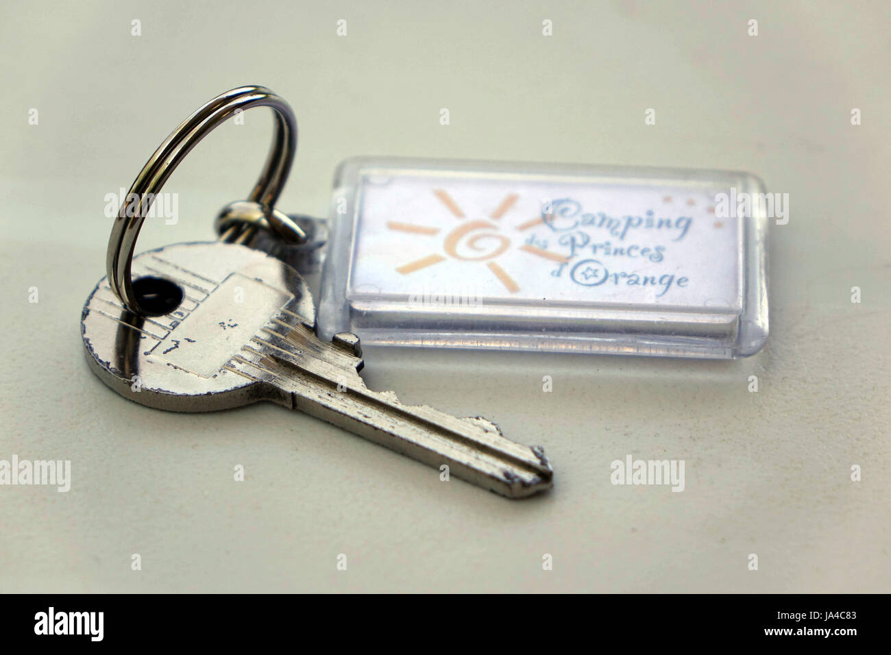 Silver key attached to campsite tag Stock Photo - Alamy