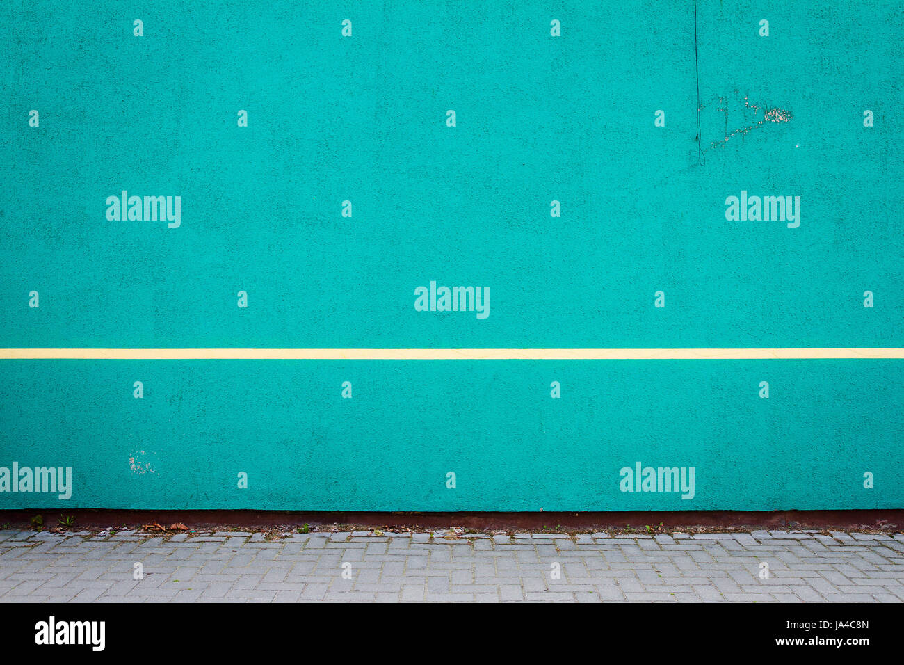 Vibrant cyan plaster wall with single yellow line Stock Photo - Alamy