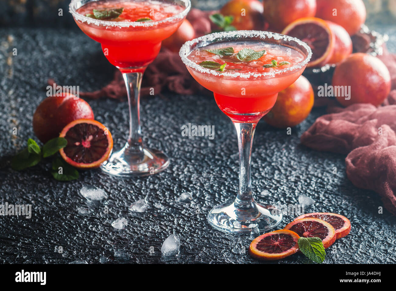Blood Orange Margarita cocktail with mint and red orange in salt rimmed ...