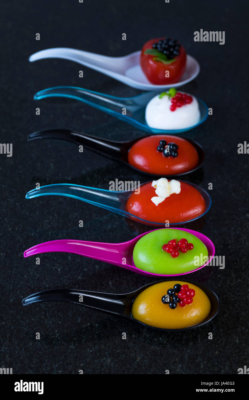 Mini desserts and meat canapes vegetable snacks in plastic cups canapes ...