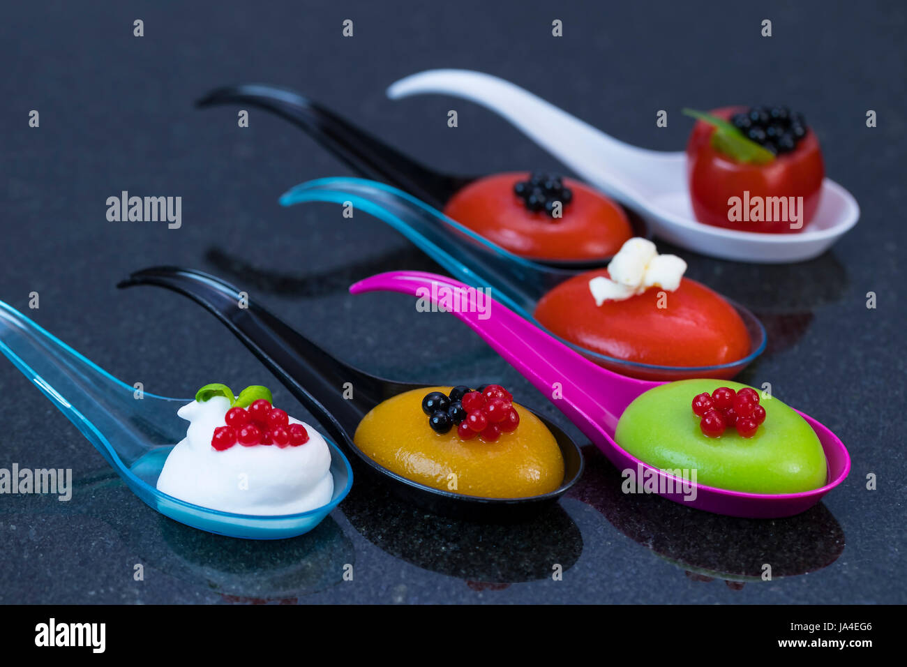 Mini desserts and meat canapes vegetable snacks in plastic cups canapes ...