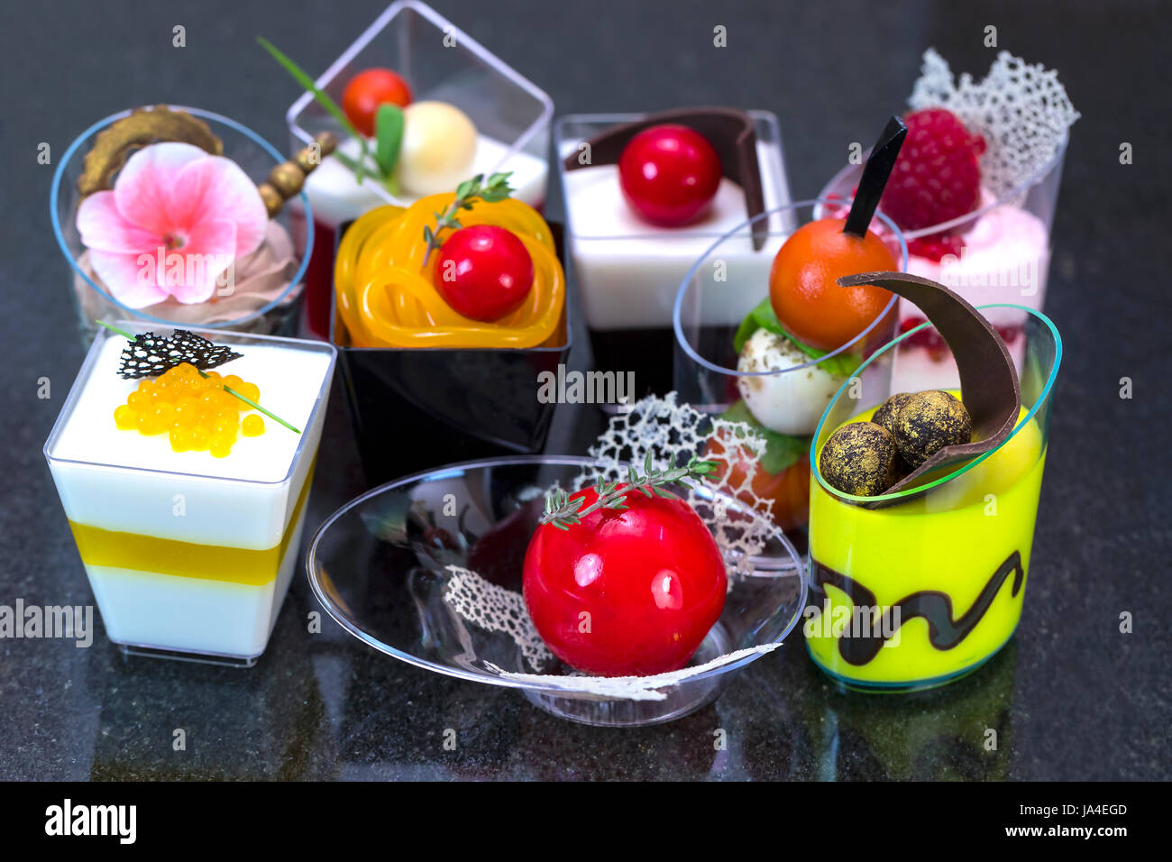 Mini desserts and meat canapes vegetable snacks in plastic cups canapes ...