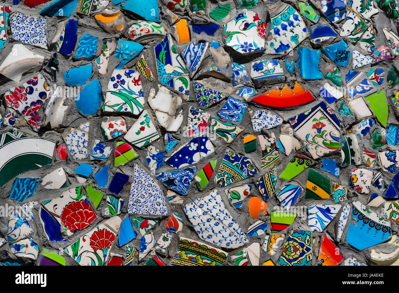 Wall with broken ceramic plates colored fragments Stock Photo - Alamy