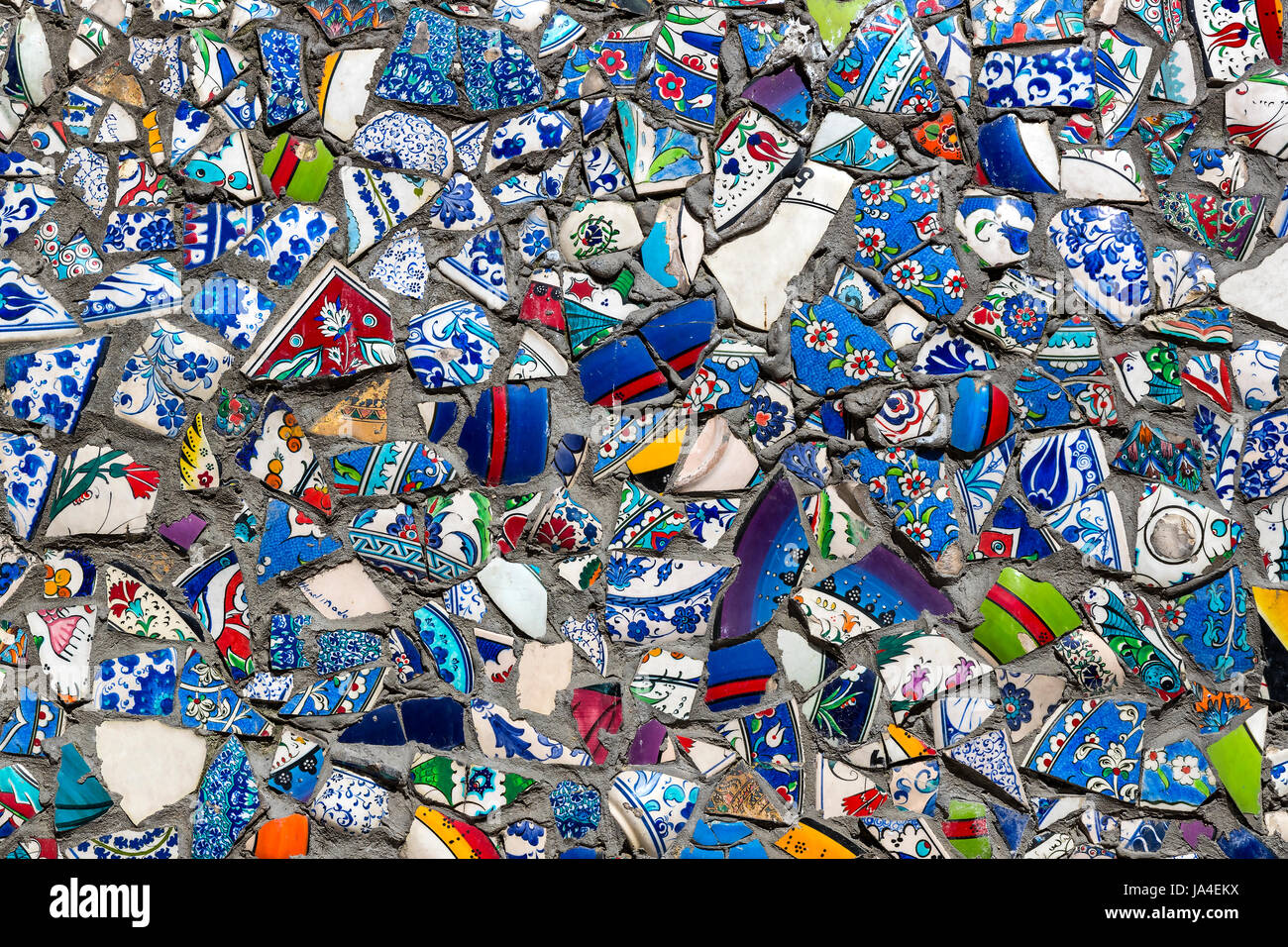 Wall with broken ceramic plates colored fragments Stock Photo - Alamy