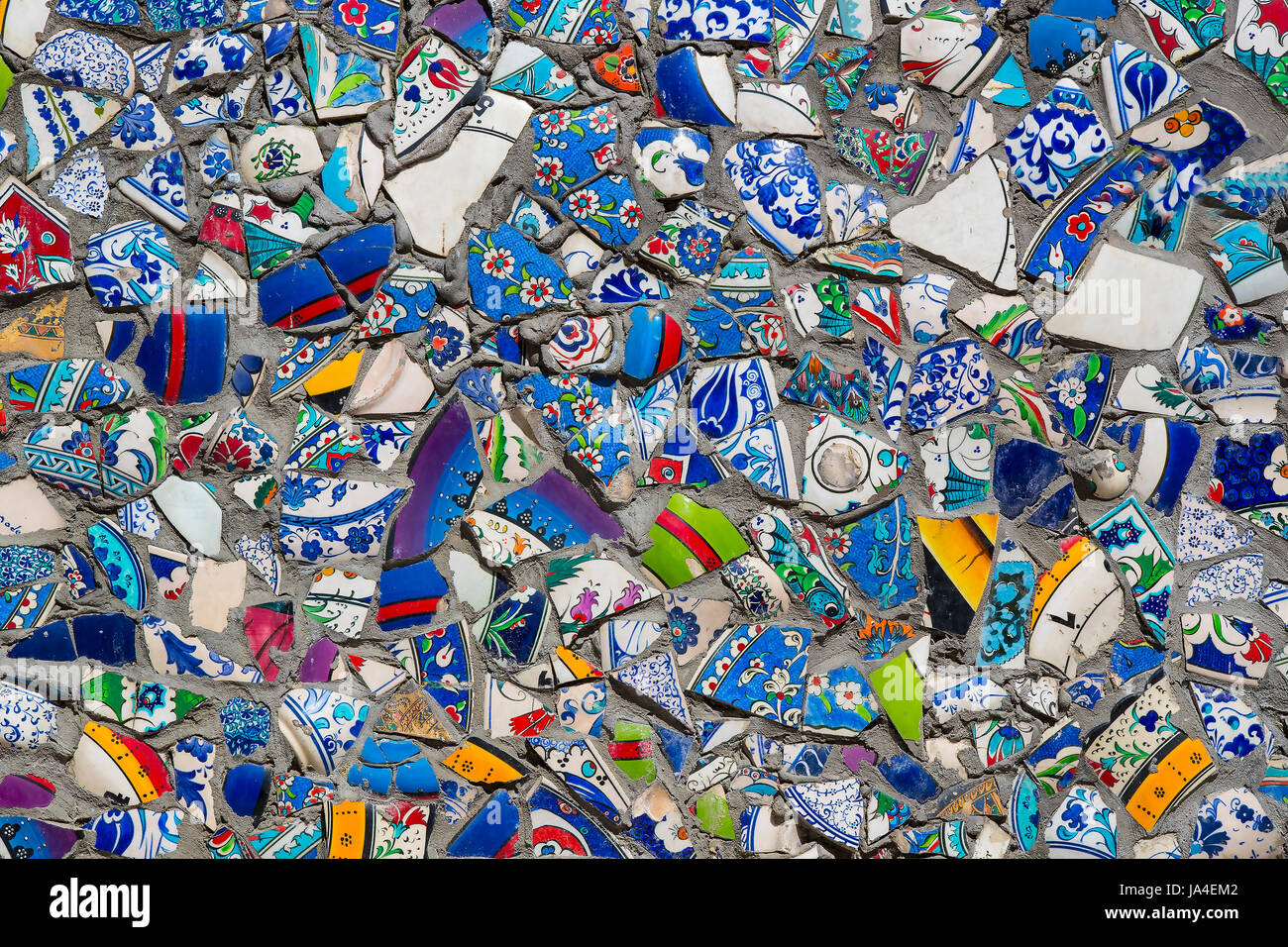 Wall with broken ceramic plates colored fragments Stock Photo - Alamy