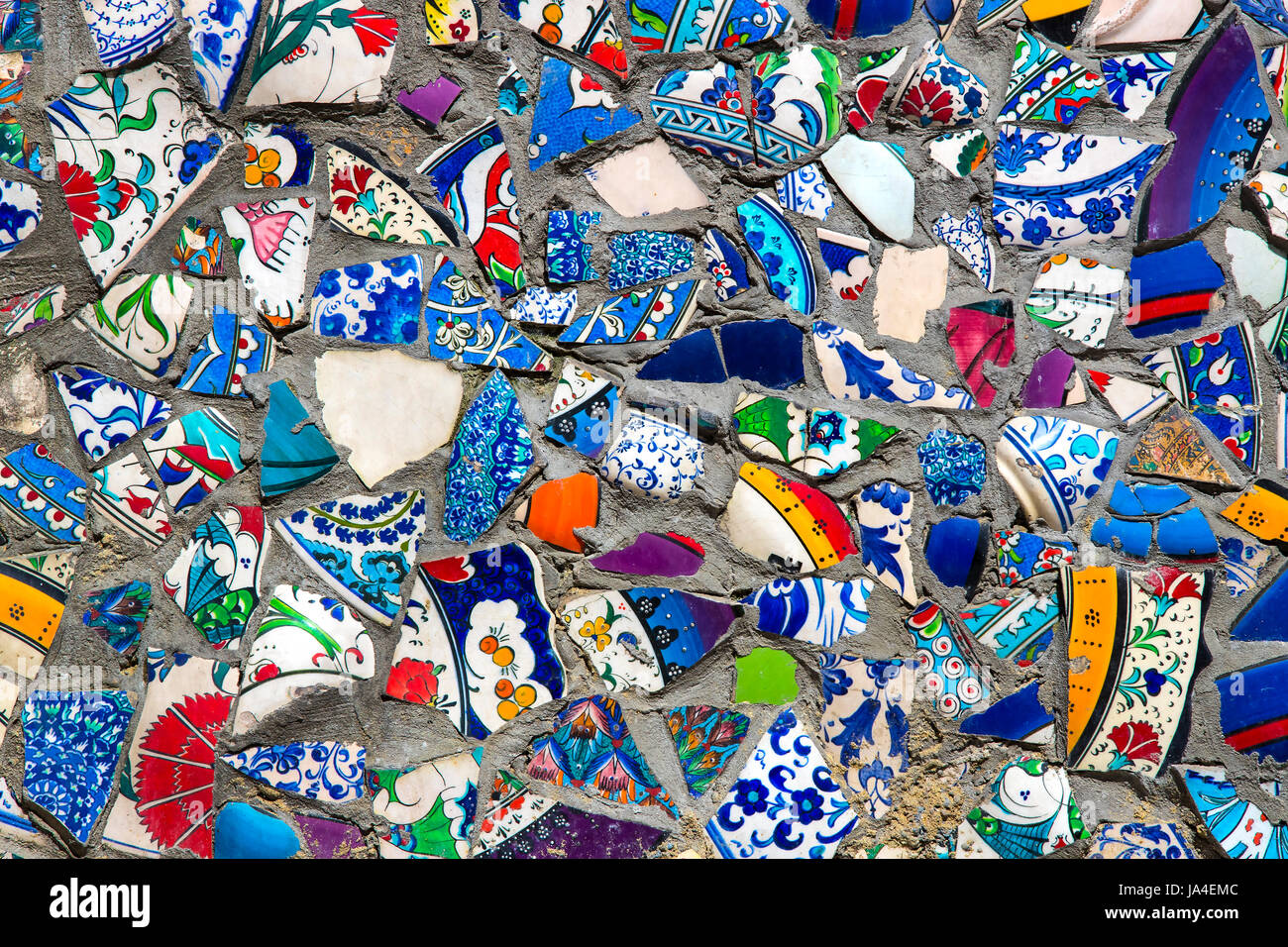 Wall with broken ceramic plates colored fragments Stock Photo - Alamy