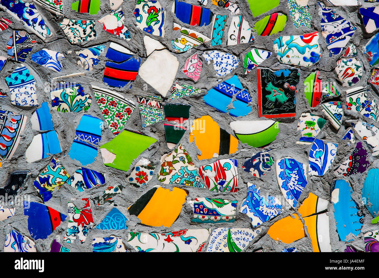 Wall with broken ceramic plates colored fragments Stock Photo - Alamy