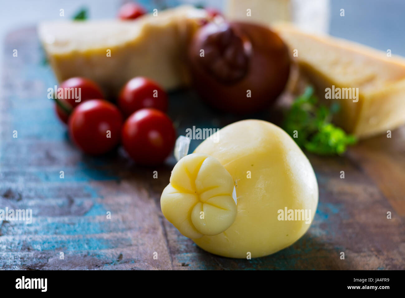 Traditional Italian hard cheese Provolone of Caciocavallo on wooden ...