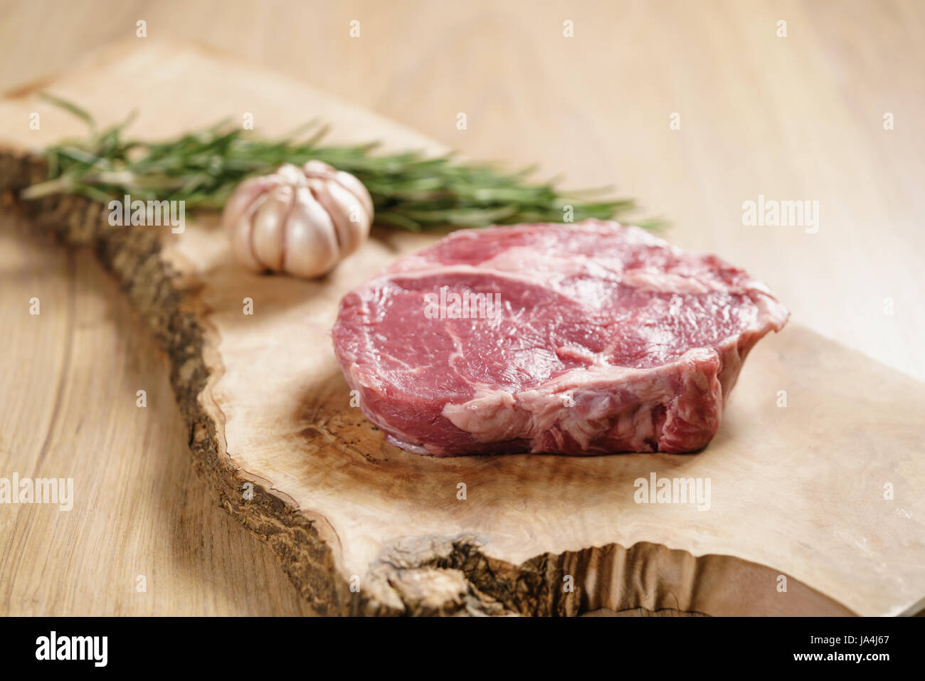 raw rib eye steak on board closeup Stock Photo - Alamy