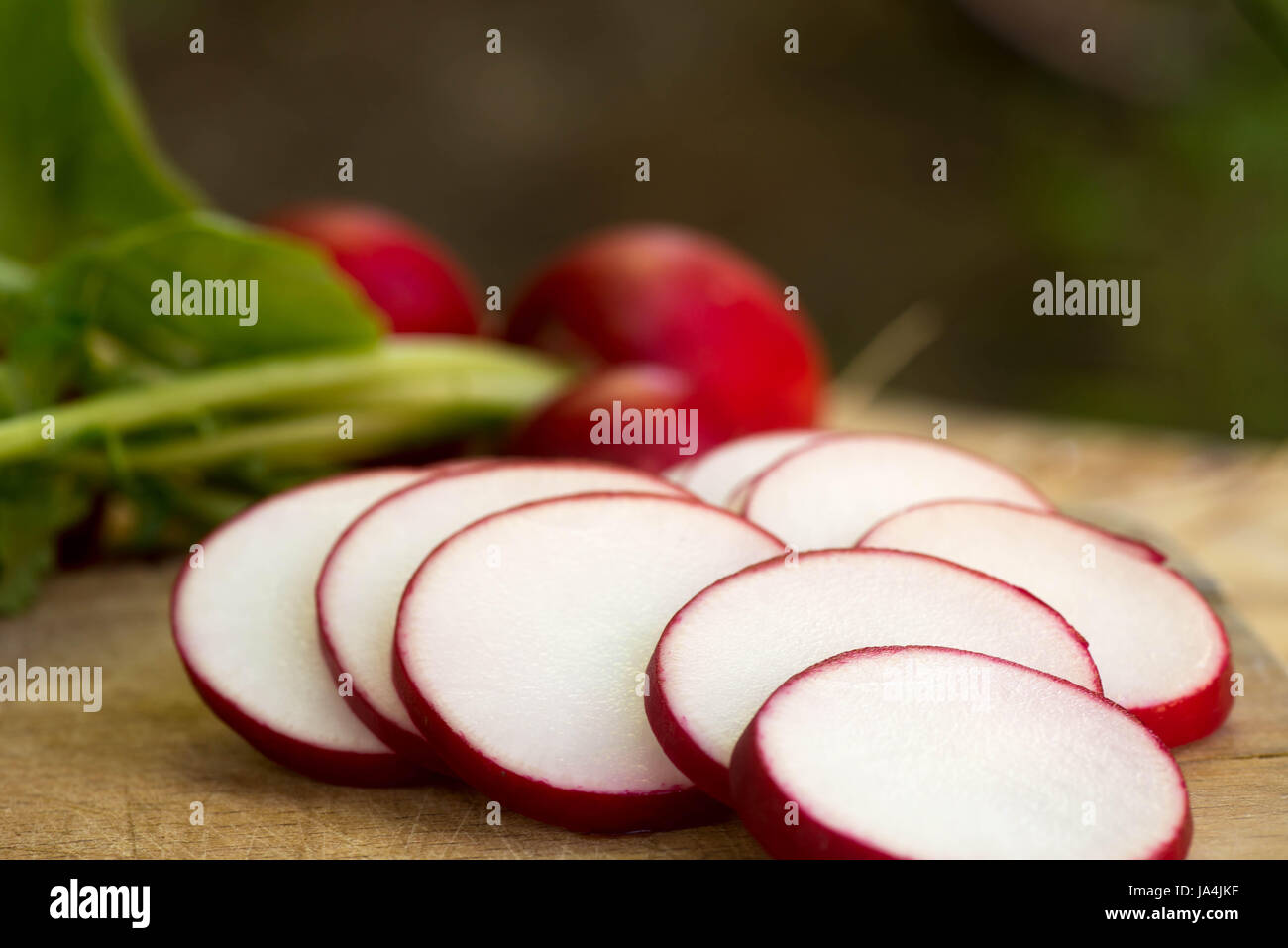 sliced radish on wooden table closeup Stock Photo - Alamy