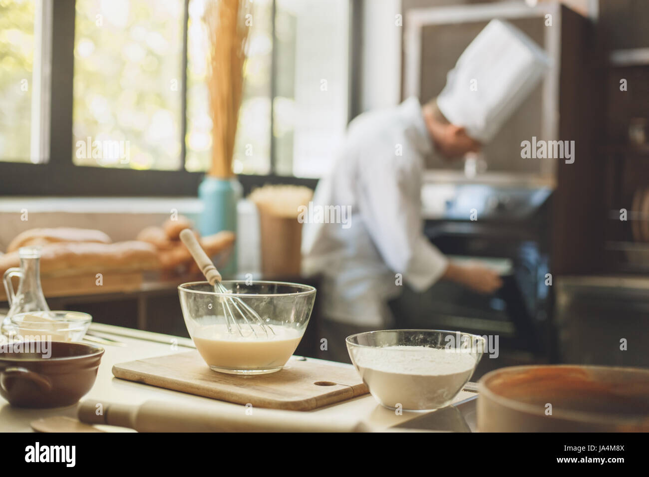 Bakery chef cooking bake in the kitchen professional Stock Photo - Alamy