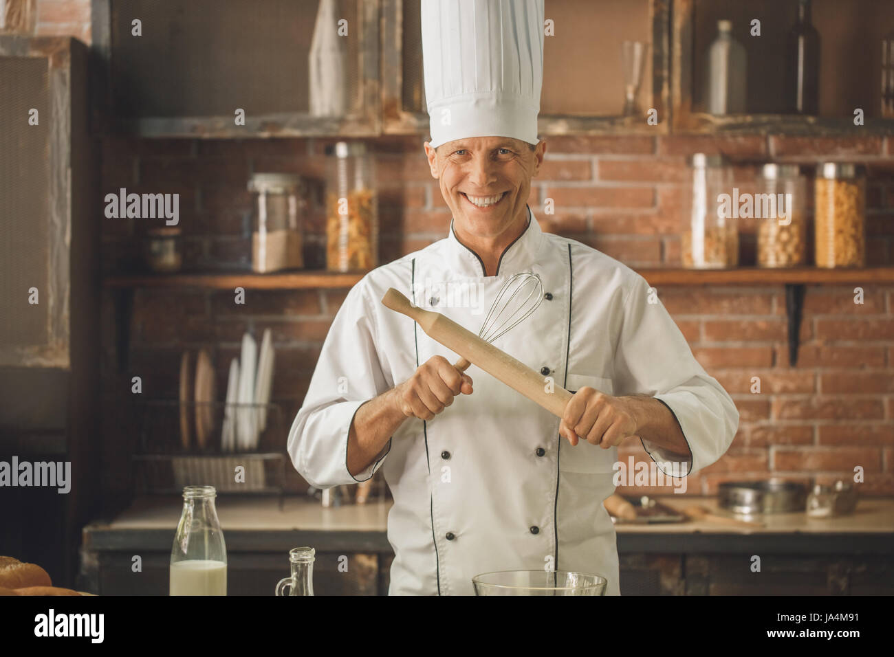 Bakery chef cooking bake in the kitchen professional Stock Photo - Alamy