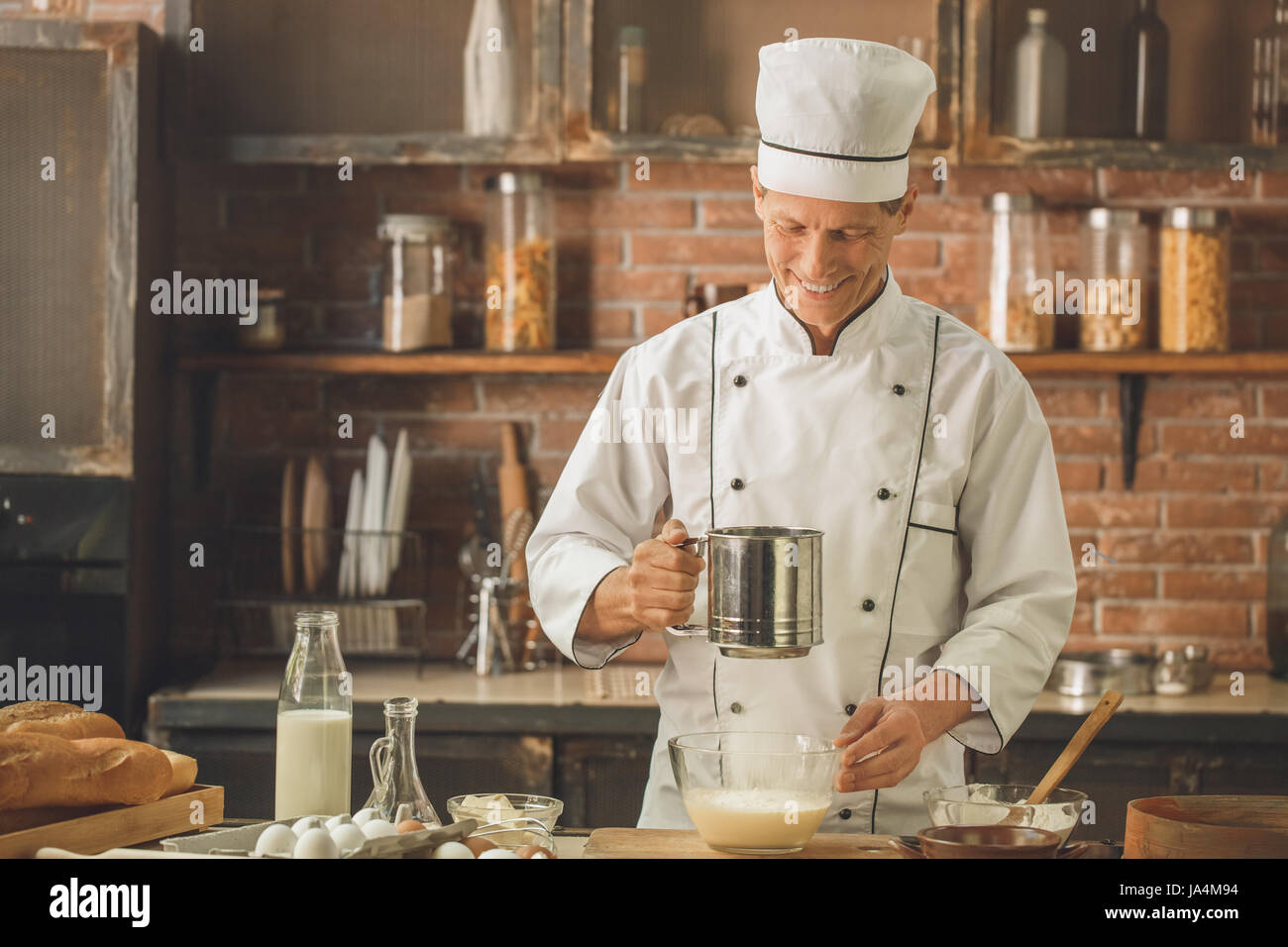 Bakery chef cooking bake in the kitchen professional Stock Photo - Alamy