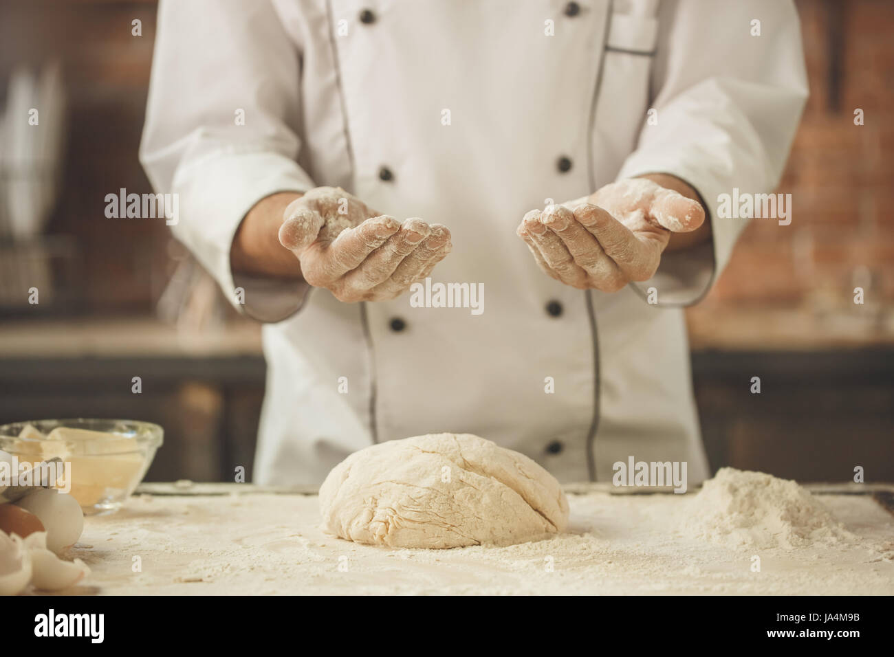 Bakery chef cooking bake in the kitchen professional Stock Photo - Alamy