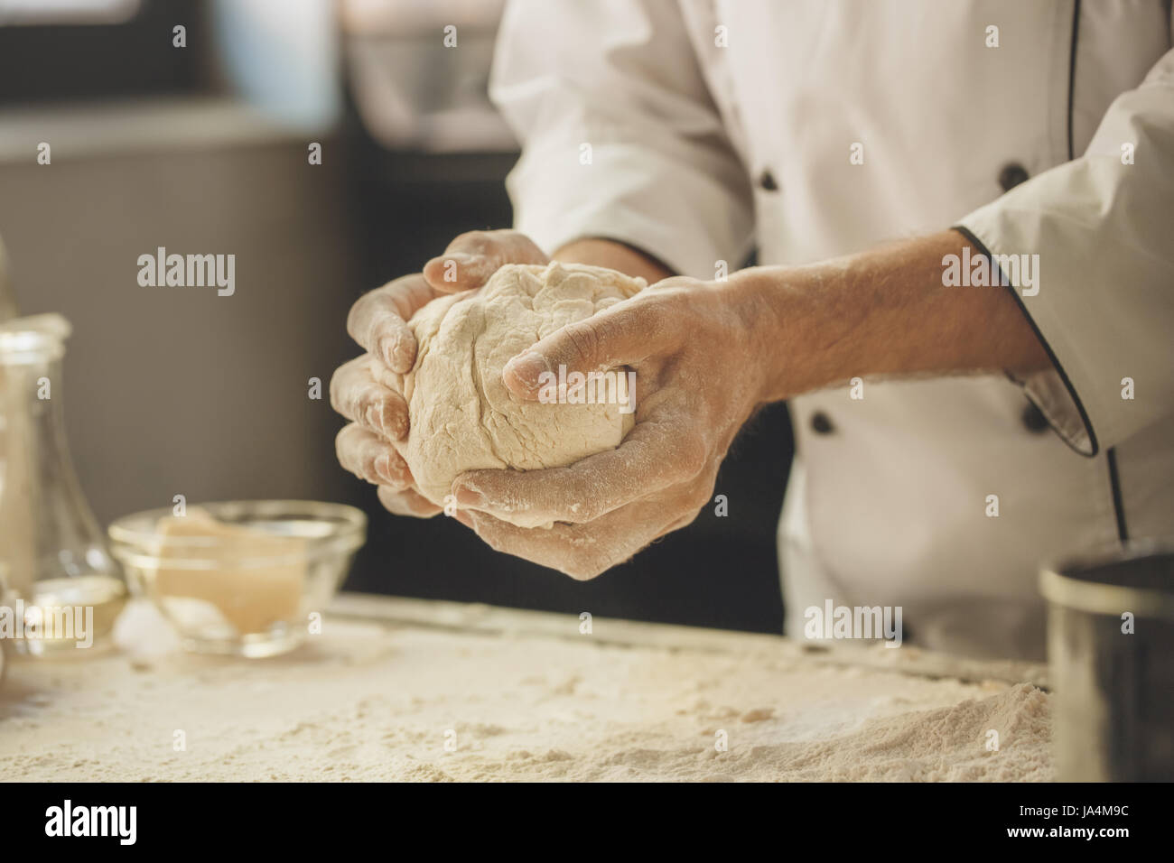 Bakery chef cooking bake in the kitchen professional Stock Photo - Alamy