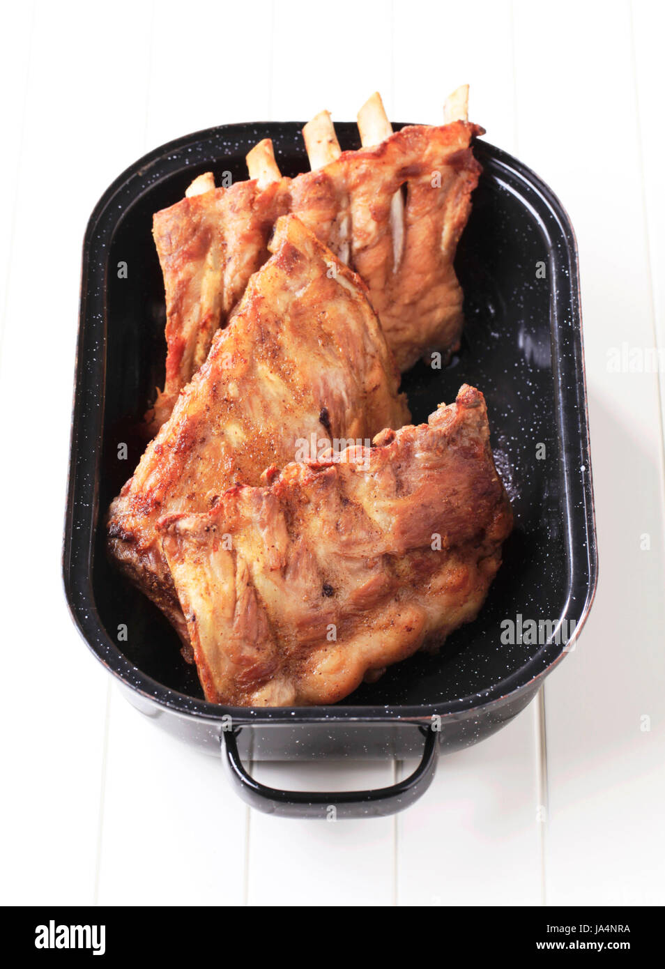 Oven-roasted rack of pork ribs in a pan Stock Photo - Alamy