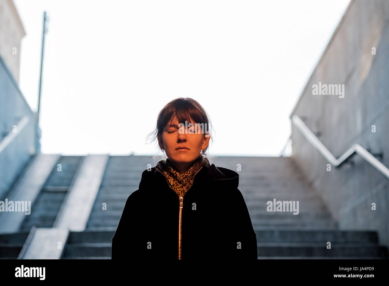 The girl goes down the stairs in the underpass. She is afraid to go there alone Stock Photo - Alamy