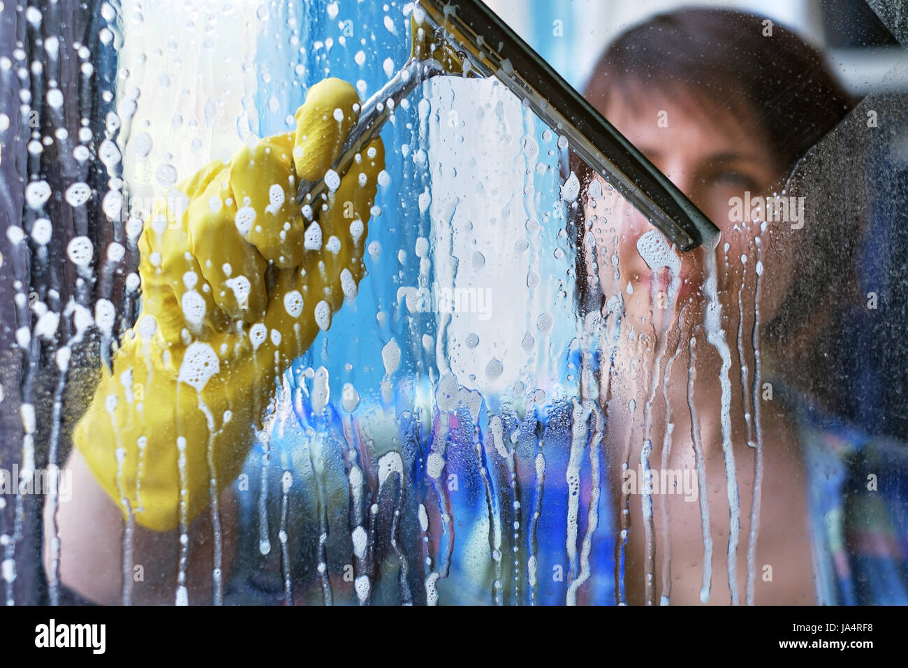A girl washes windows at home. To clean up the house Stock Photo - Alamy