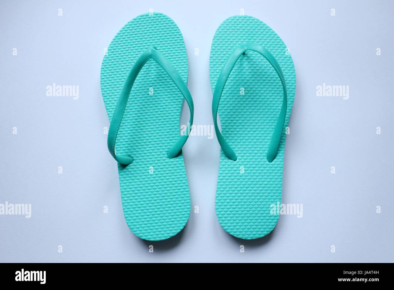 Pairs of beach shoes tong in colors on white background Stock Photo - Alamy