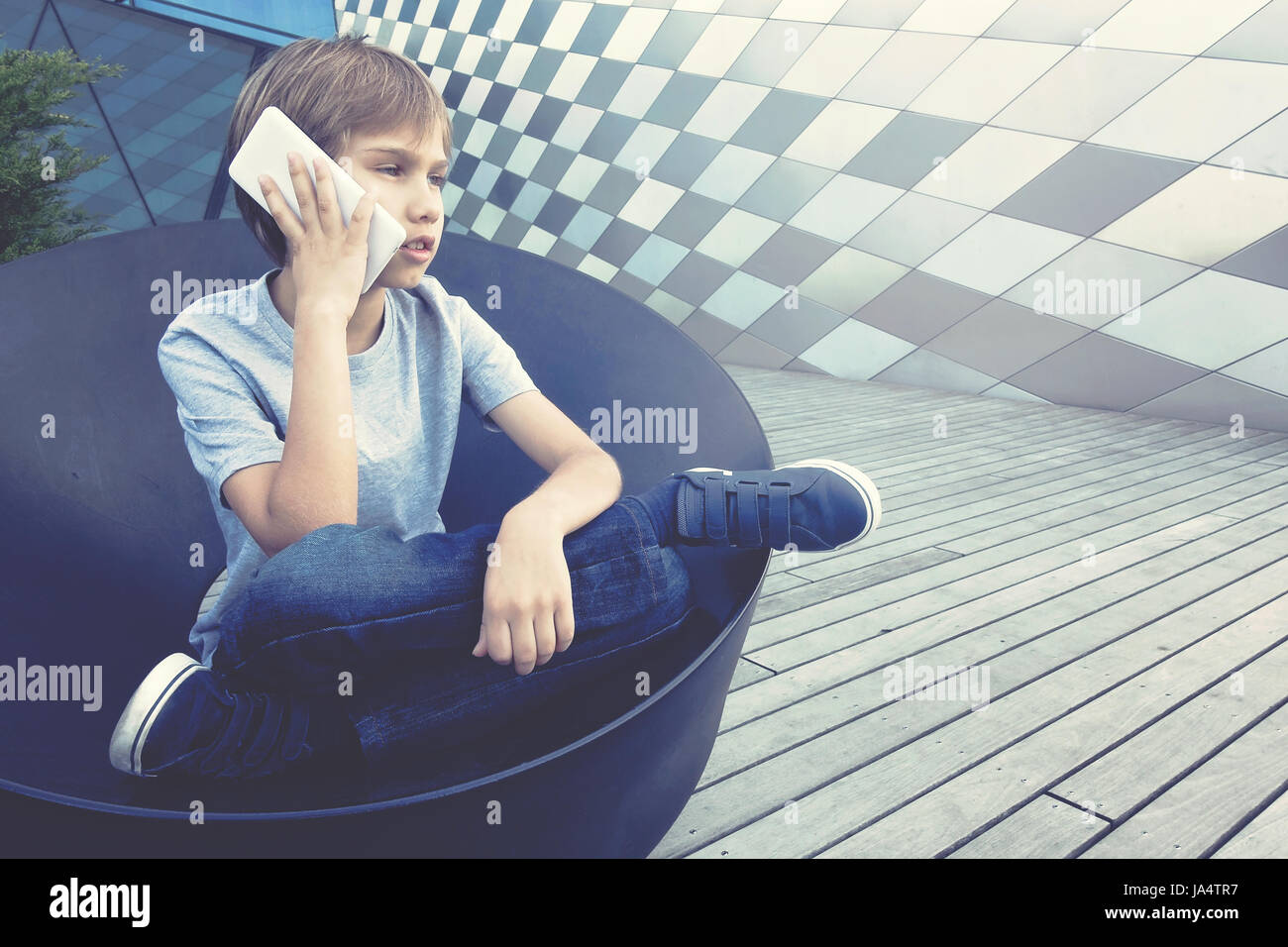 Boy talking on his phone in school hi-res stock photography and images ...