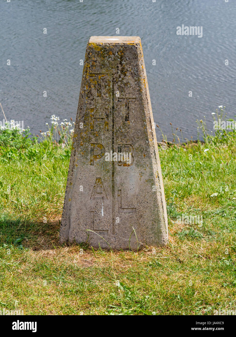 A concrete marker post by the river Tees at Stockton marking the ...