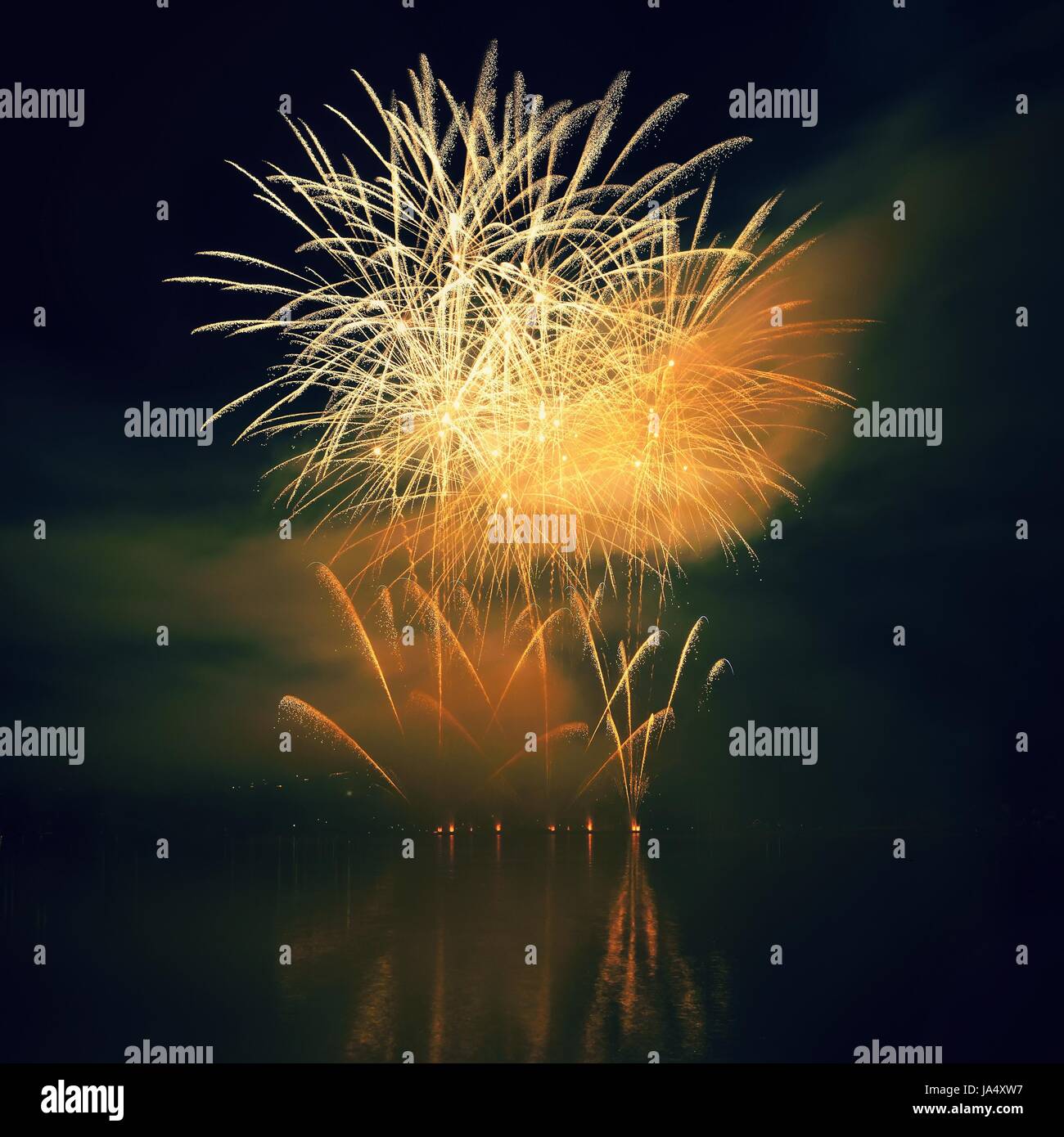 Beautiful colorful fireworks on the water surface with a clean black ...