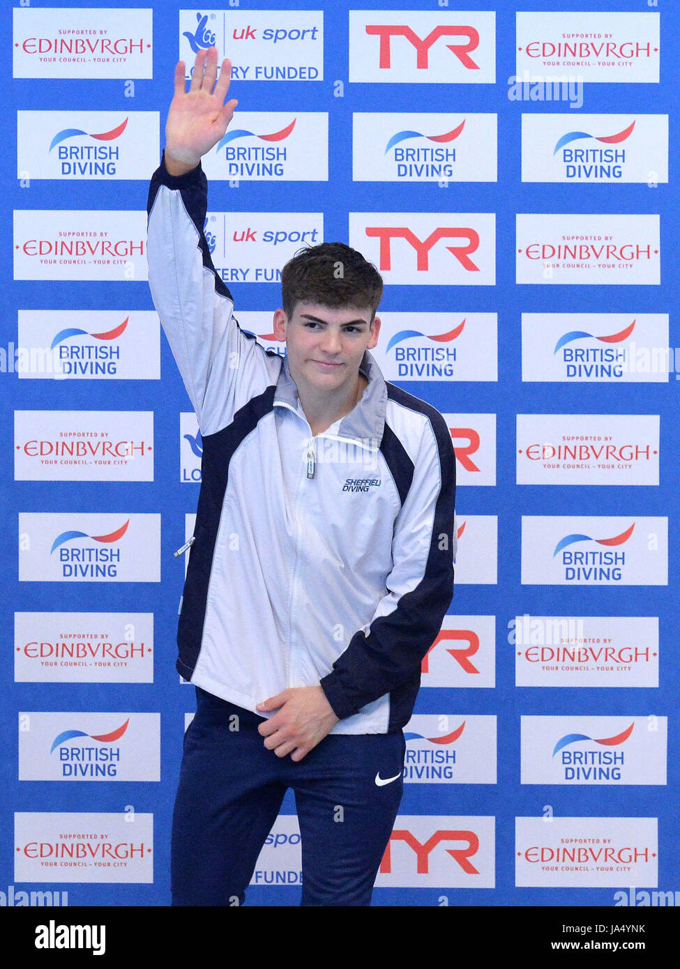 Gold medalist Ross Haslam waves to the audience at the medal ceremony ...